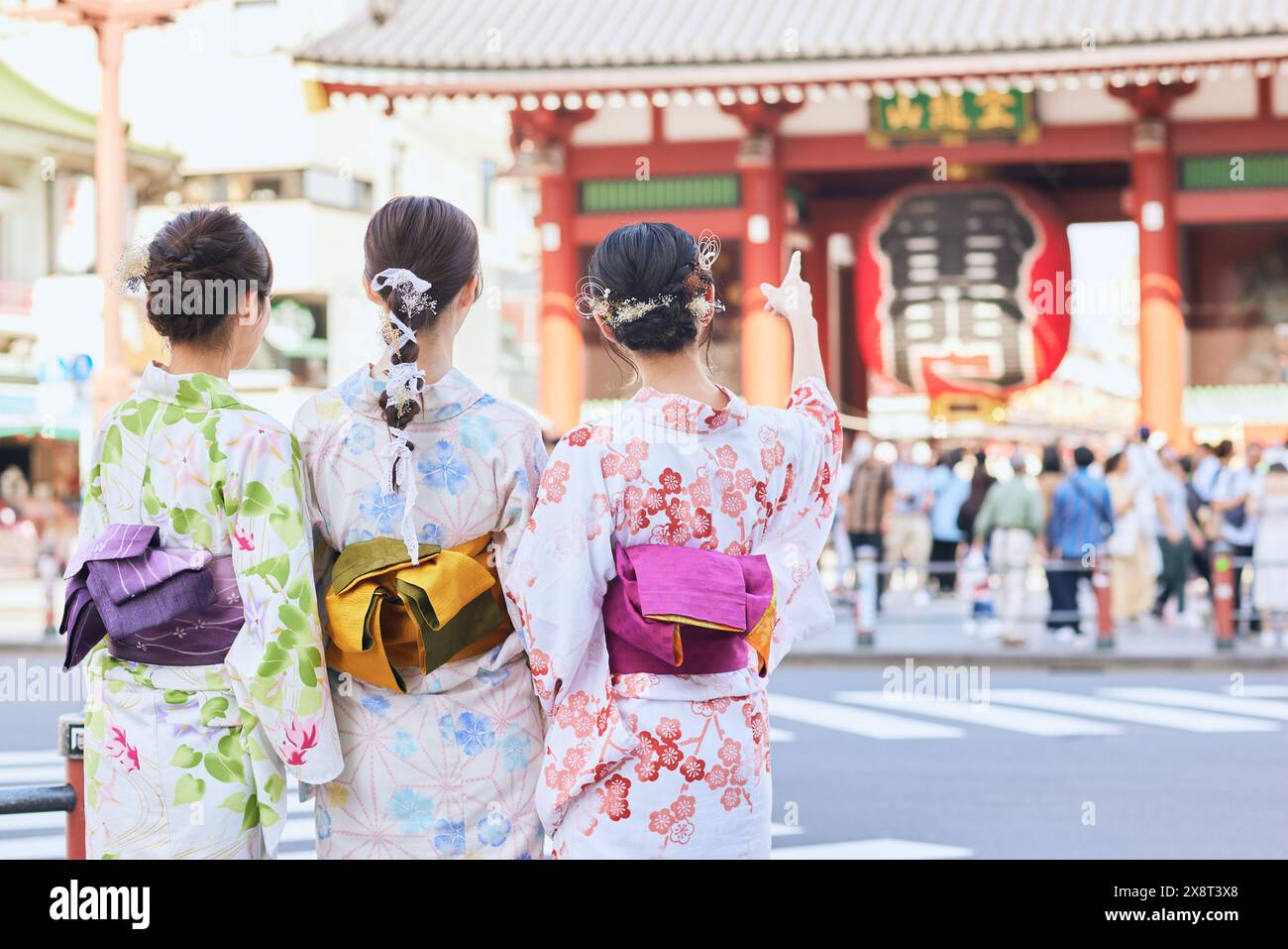 Japanese friends wearing yukata visiting traditional temple in Tokyo ...