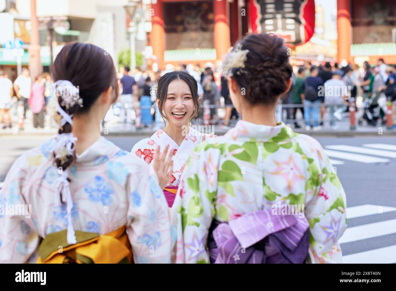 Japanese friends wearing yukata visiting traditional temple in Tokyo ...