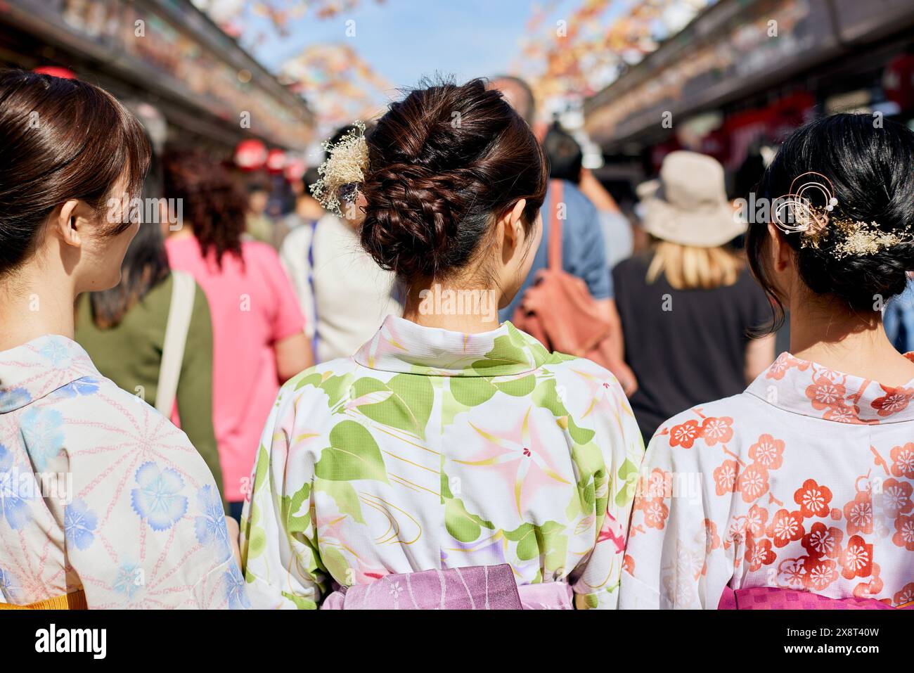 Japanese friends wearing yukata visiting traditional temple in Tokyo ...