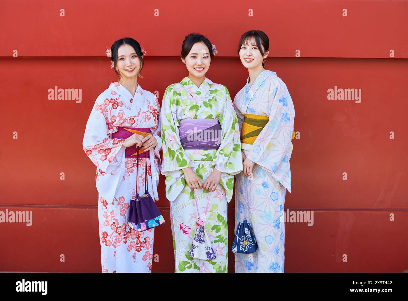 Japanese friends wearing yukata visiting traditional temple in Tokyo ...