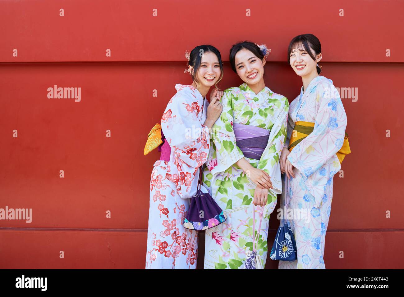 Japanese friends wearing yukata visiting traditional temple in Tokyo ...