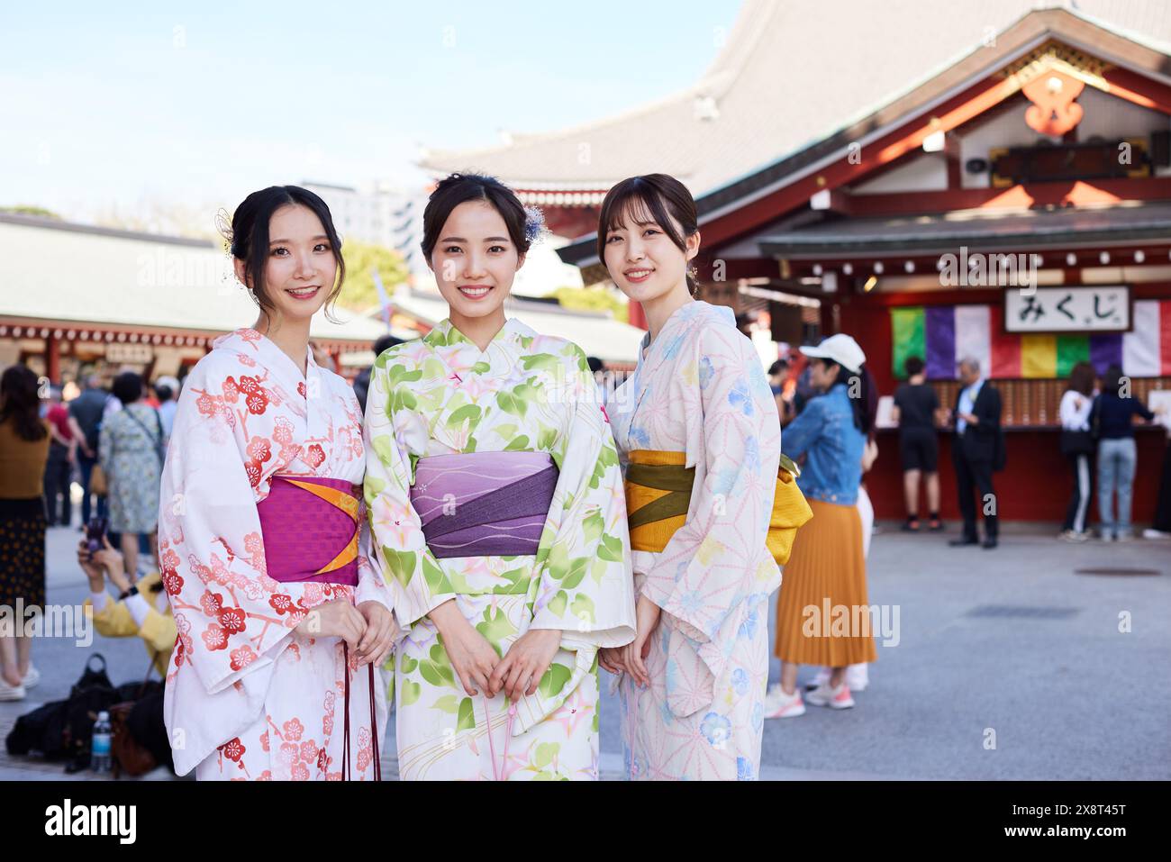 Japanese friends wearing yukata visiting traditional temple in Tokyo ...