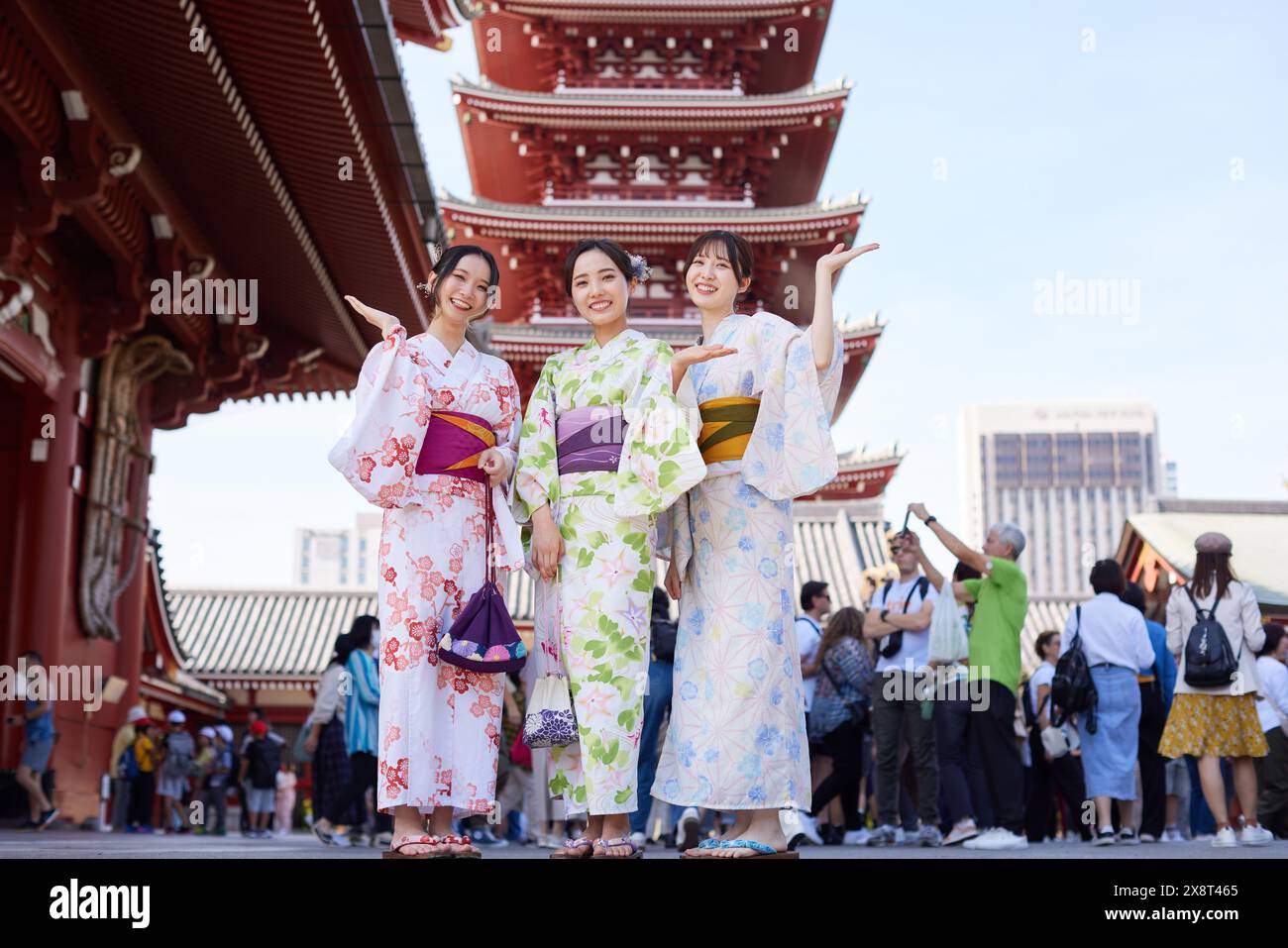 Japanese friends wearing yukata visiting traditional temple in Tokyo ...