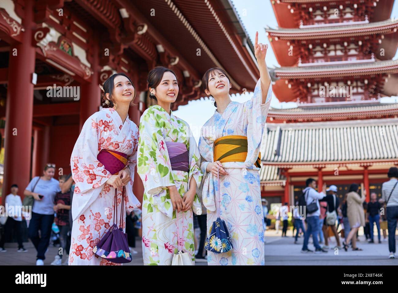 Japanese friends wearing yukata visiting traditional temple in Tokyo ...