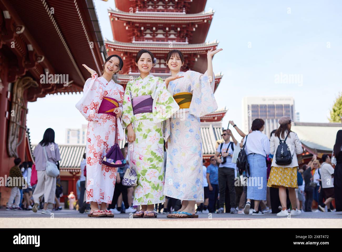 Japanese friends wearing yukata visiting traditional temple in Tokyo ...