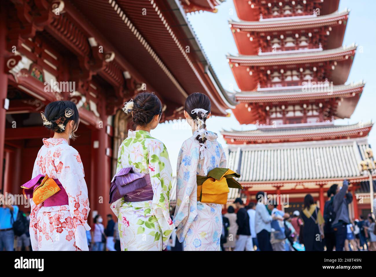 Japanese friends wearing yukata visiting traditional temple in Tokyo ...