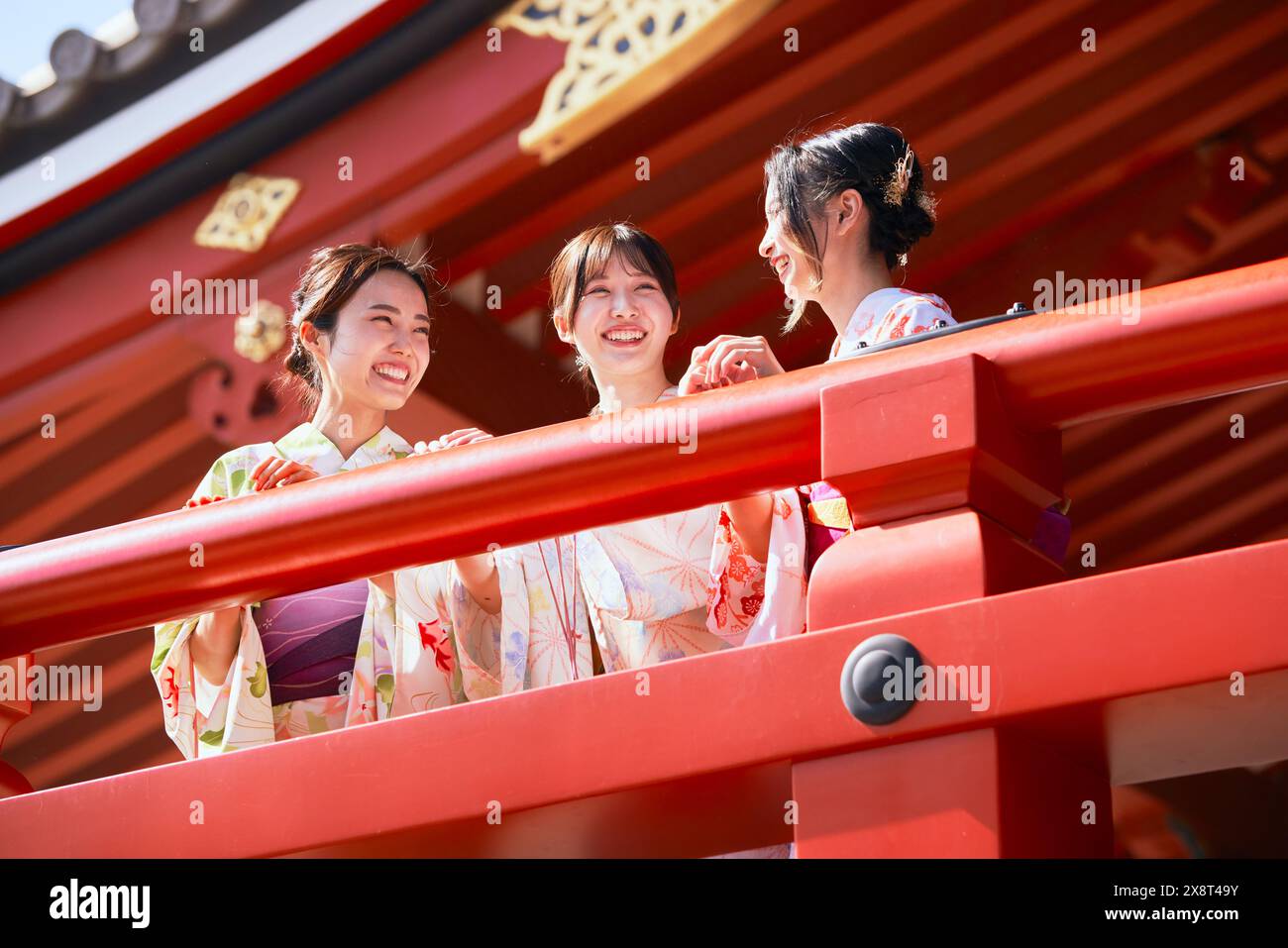 Japanese friends wearing yukata visiting traditional temple in Tokyo ...