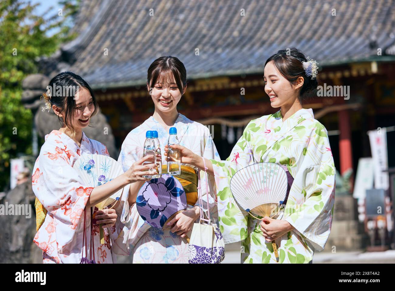 Japanese friends wearing yukata visiting traditional temple in Tokyo ...