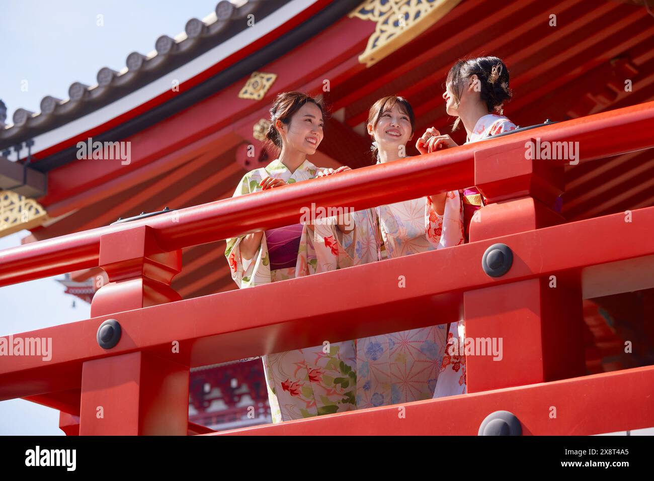 Japanese friends wearing yukata visiting traditional temple in Tokyo ...