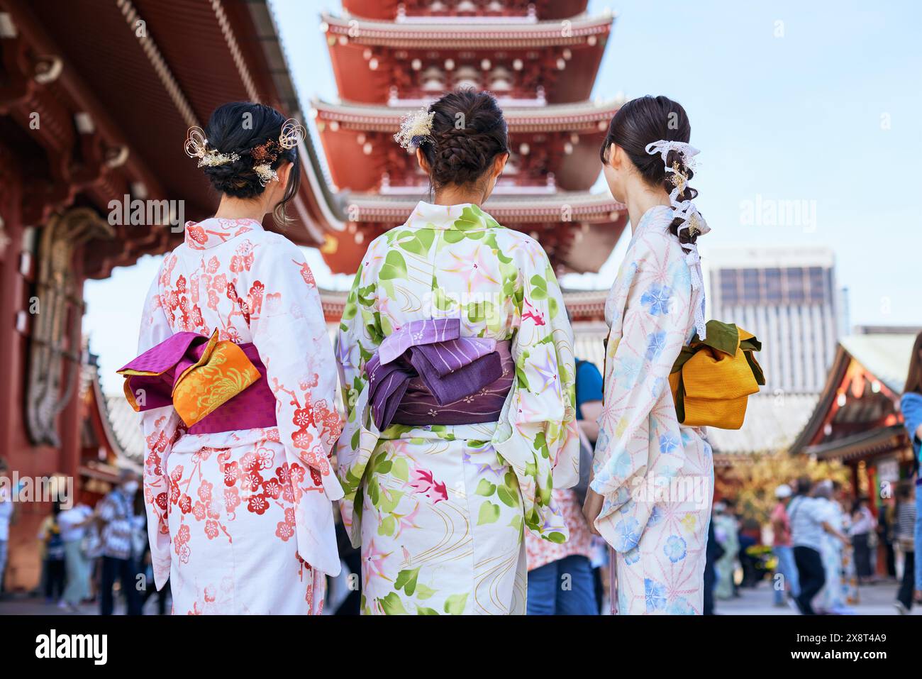 Japanese friends wearing yukata visiting traditional temple in Tokyo ...