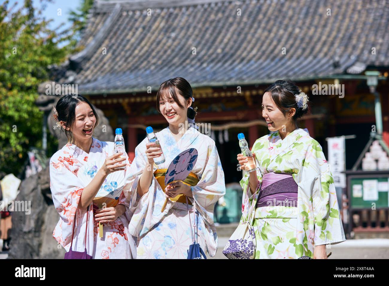 Japanese friends wearing yukata visiting traditional temple in Tokyo ...