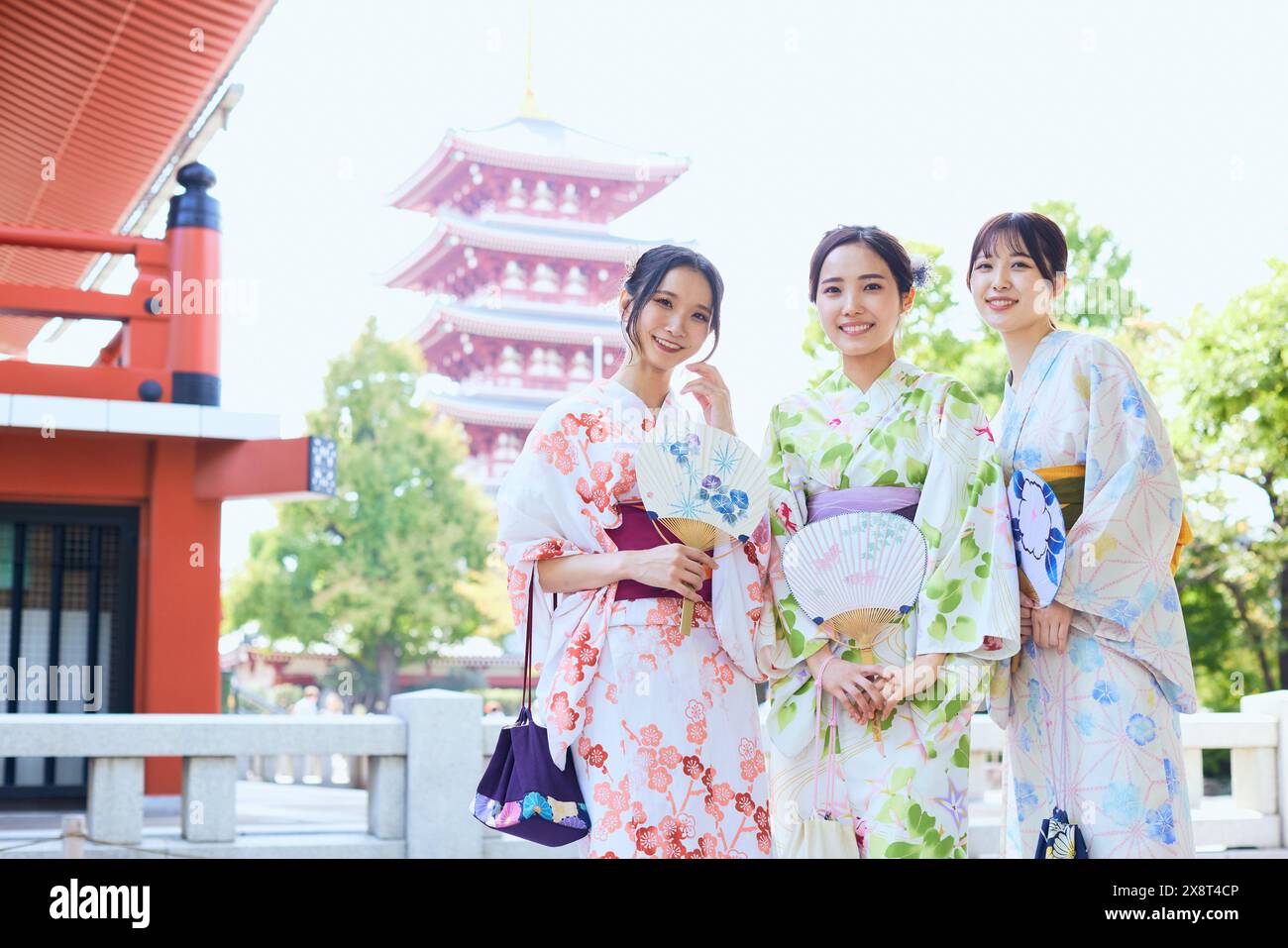 Japanese friends wearing yukata visiting traditional temple in Tokyo ...