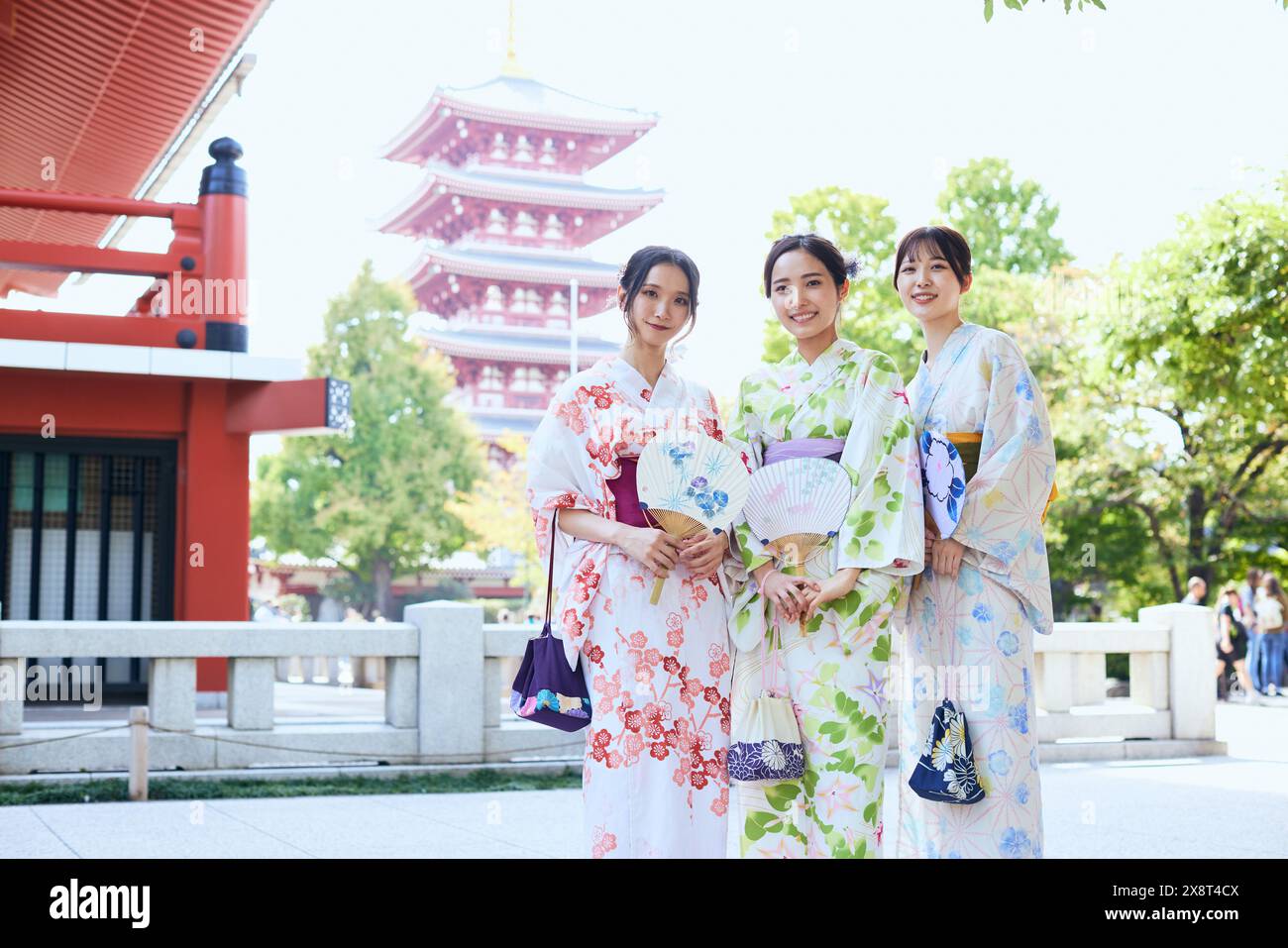 Japanese friends wearing yukata visiting traditional temple in Tokyo ...