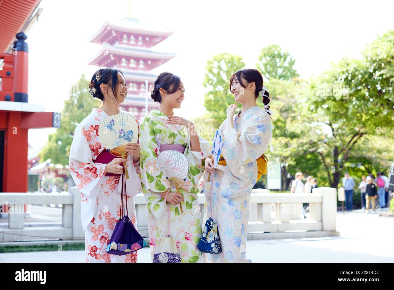 Japanese friends wearing yukata visiting traditional temple in Tokyo ...