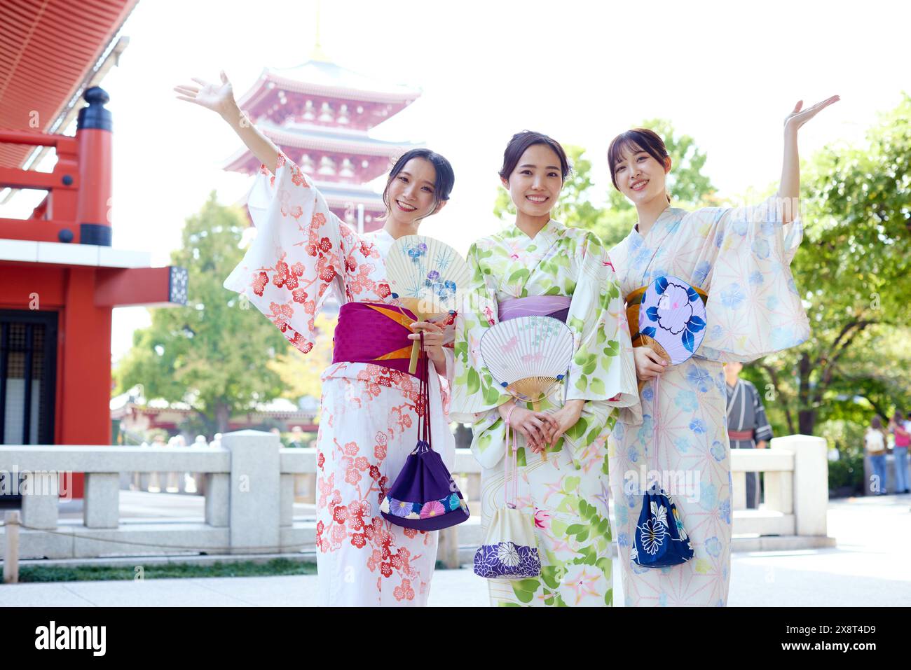 Japanese friends wearing yukata visiting traditional temple in Tokyo ...