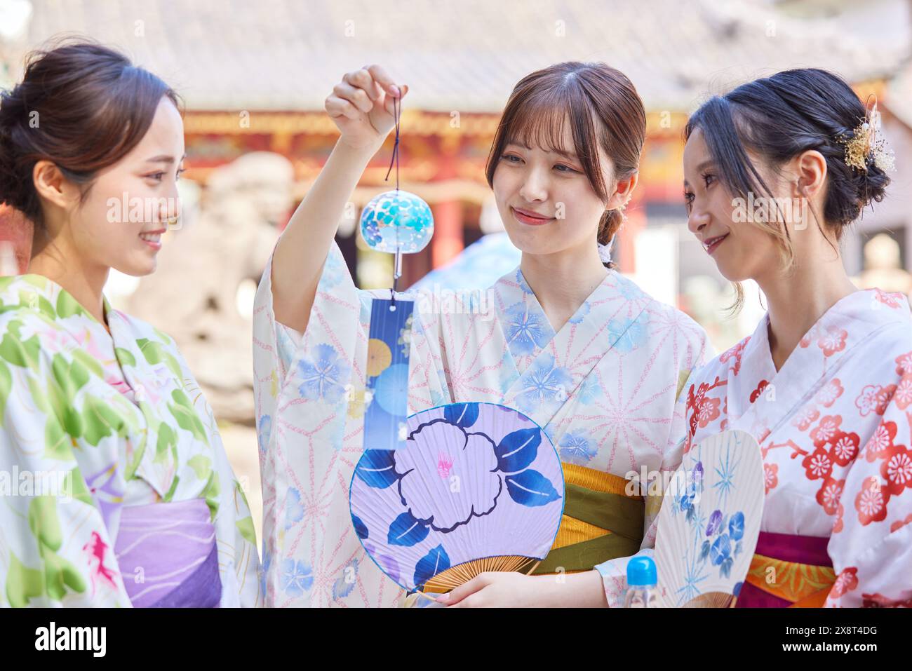 Japanese friends wearing yukata visiting traditional temple in Tokyo ...
