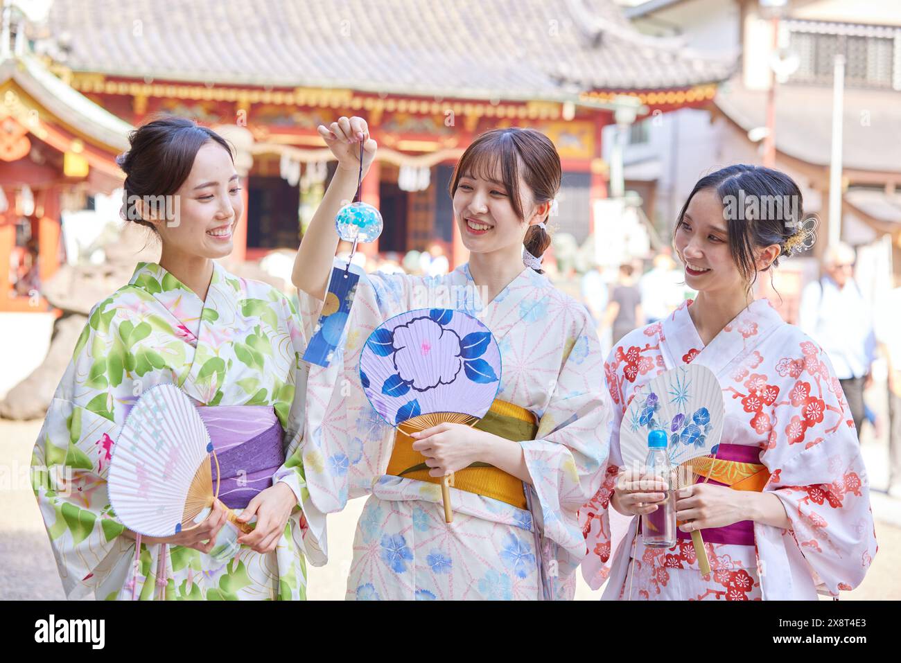 Japanese friends wearing yukata visiting traditional temple in Tokyo ...