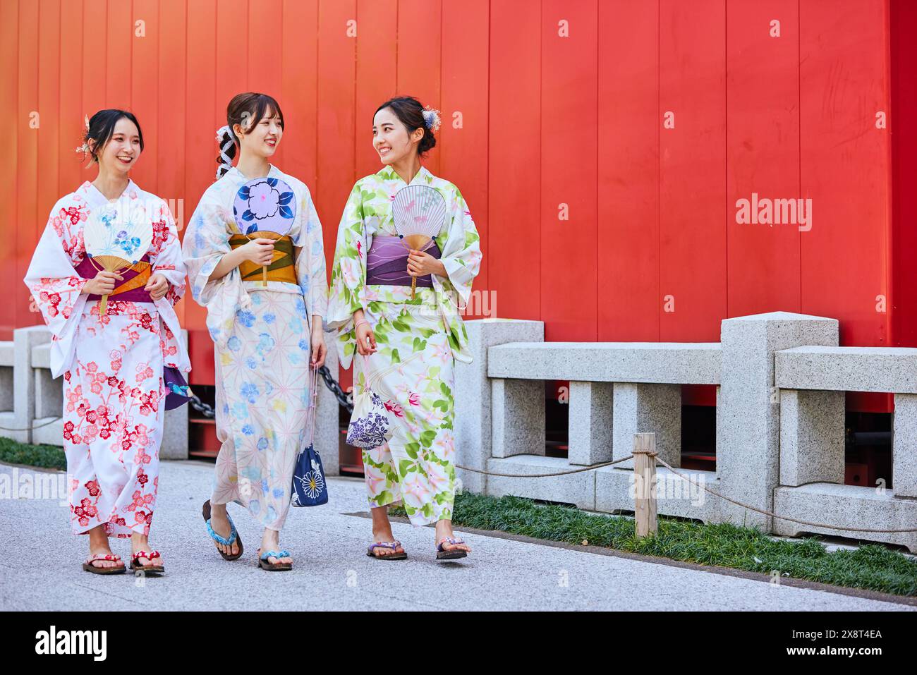 Japanese friends wearing yukata visiting traditional temple in Tokyo ...
