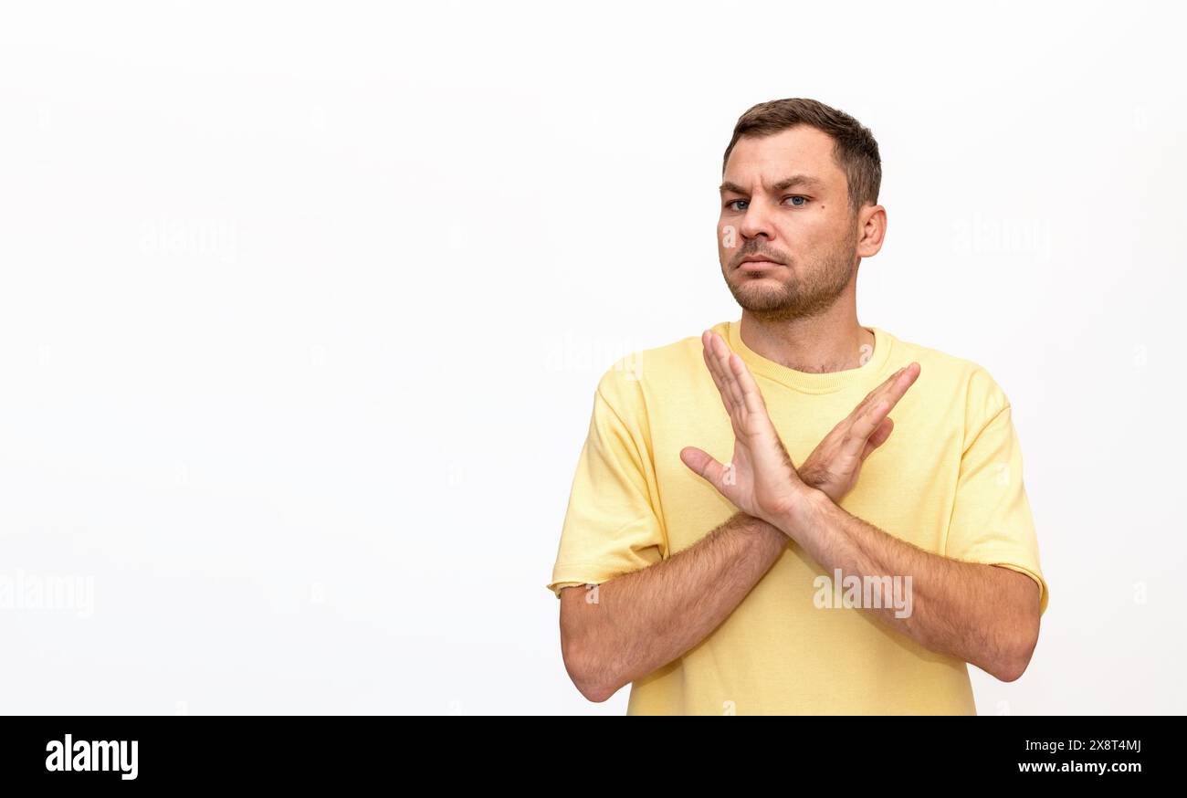 Male person wearing yellow t-shirt stands on white background and ...