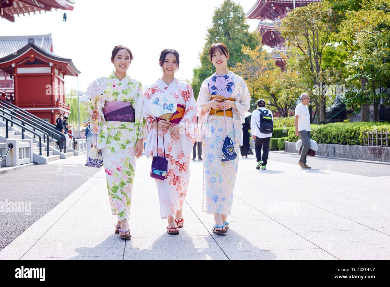 Japanese friends wearing yukata visiting traditional temple in Tokyo ...