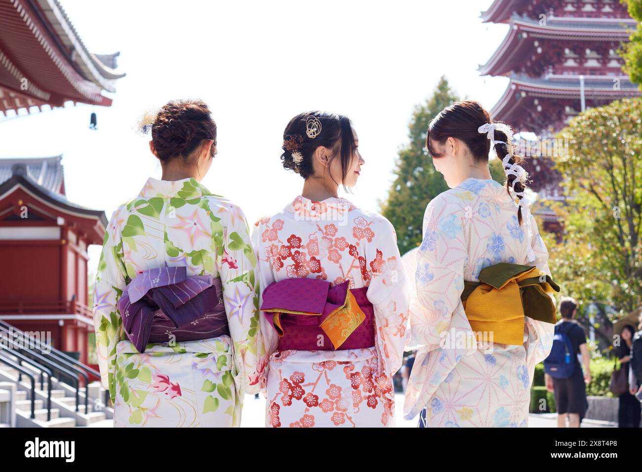 Japanese friends wearing yukata visiting traditional temple in Tokyo ...