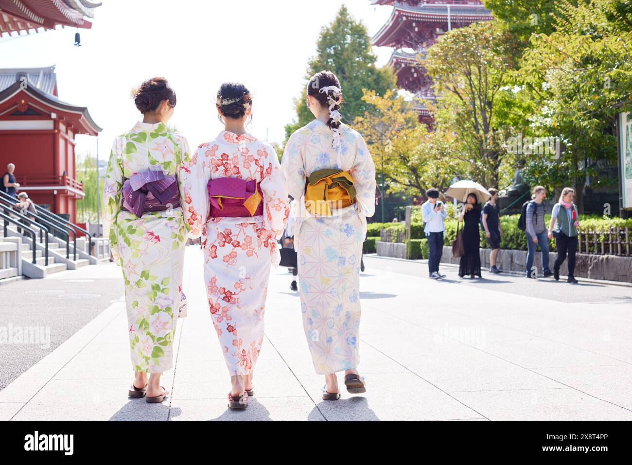 Japanese friends wearing yukata visiting traditional temple in Tokyo ...