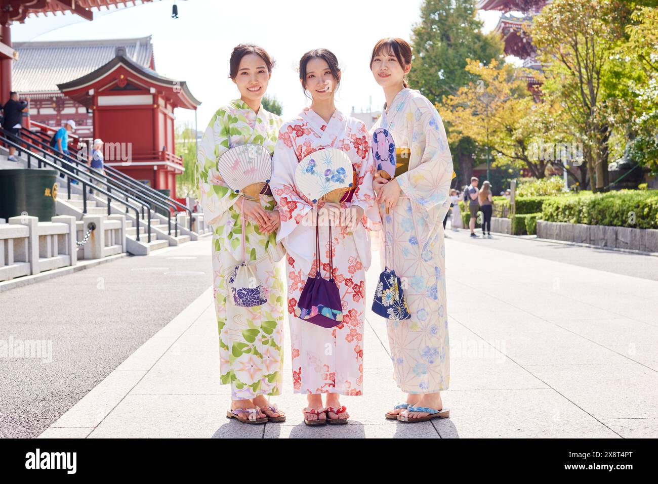 Japanese friends wearing yukata visiting traditional temple in Tokyo ...