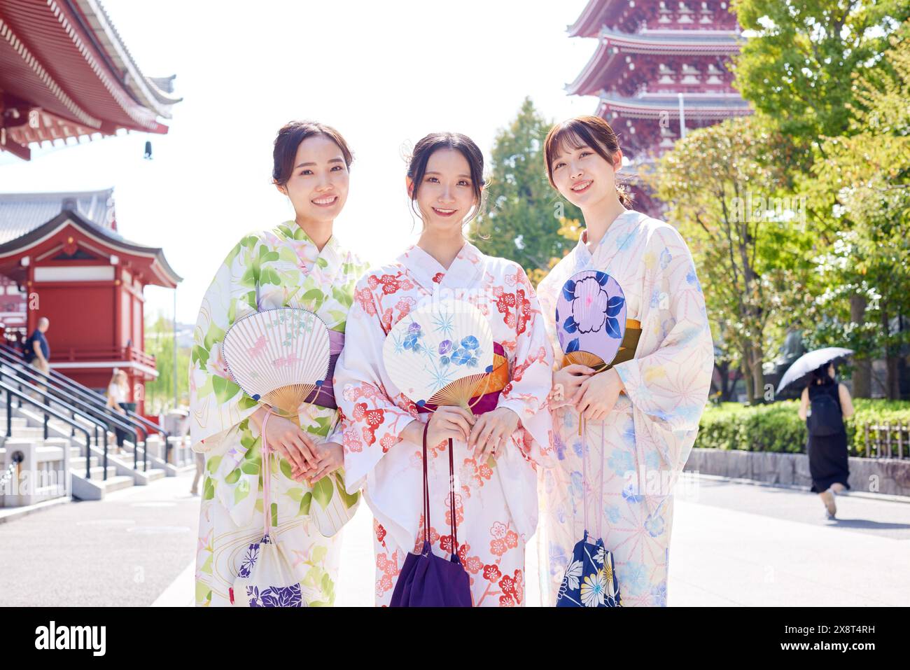 Japanese friends wearing yukata visiting traditional temple in Tokyo ...