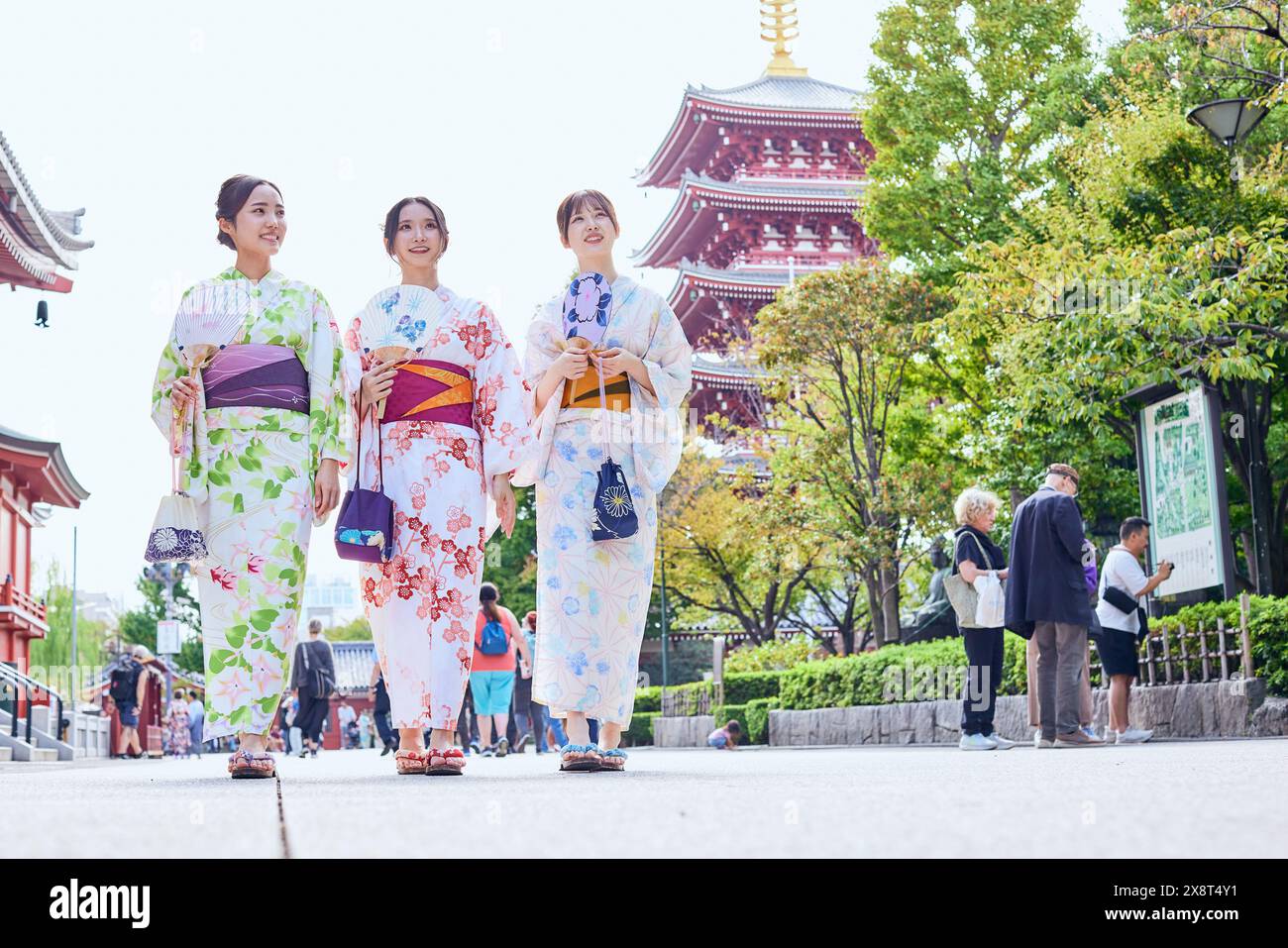 Japanese friends wearing yukata visiting traditional temple in Tokyo ...