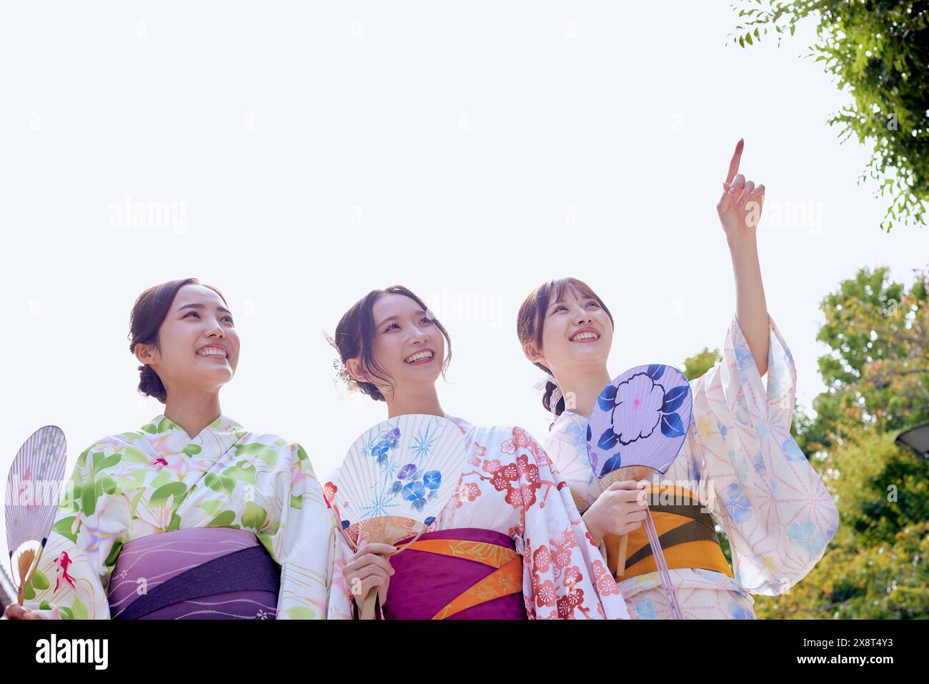 Japanese friends wearing yukata visiting traditional temple in Tokyo ...