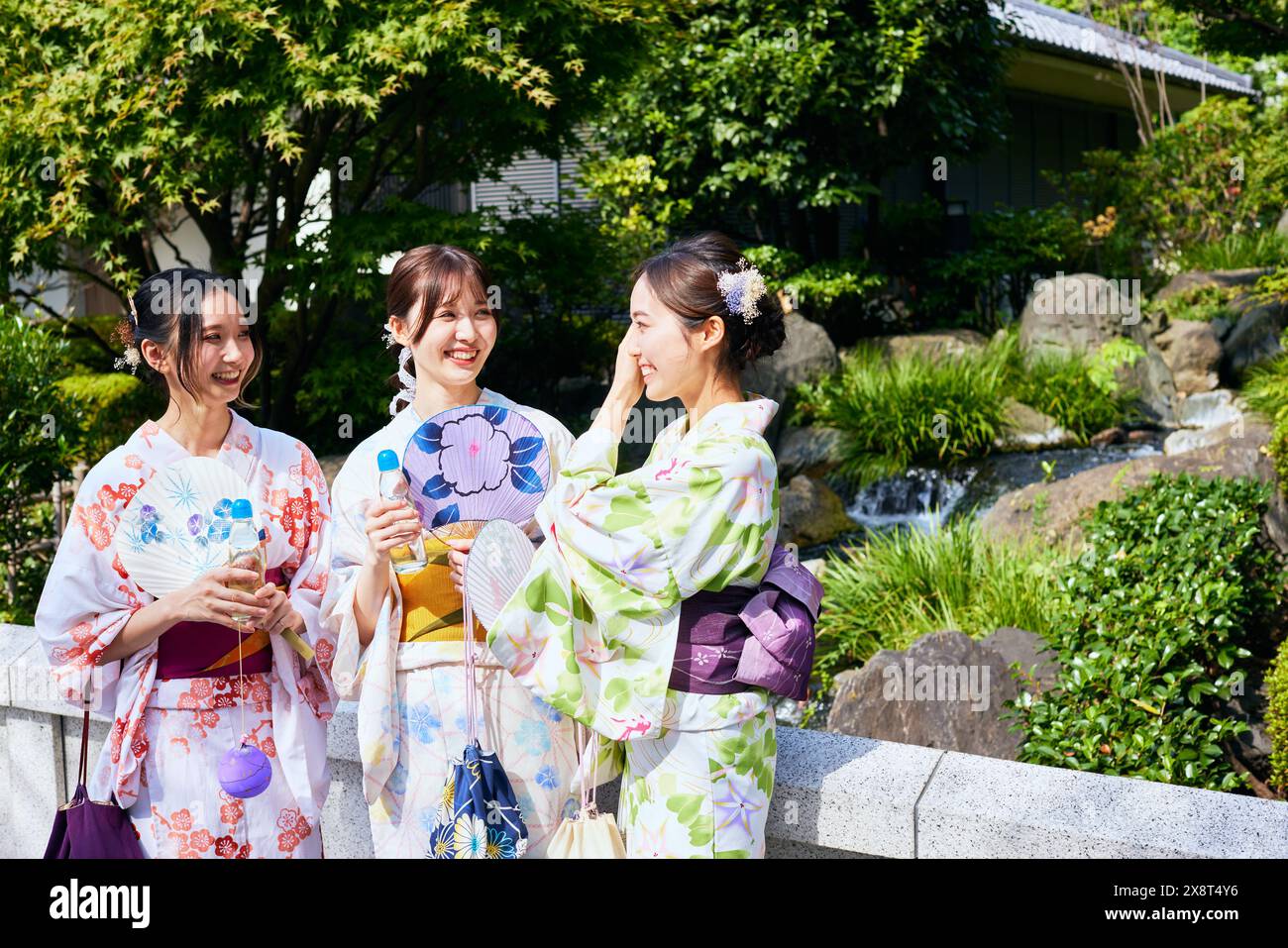 Japanese friends wearing yukata visiting traditional temple in Tokyo ...