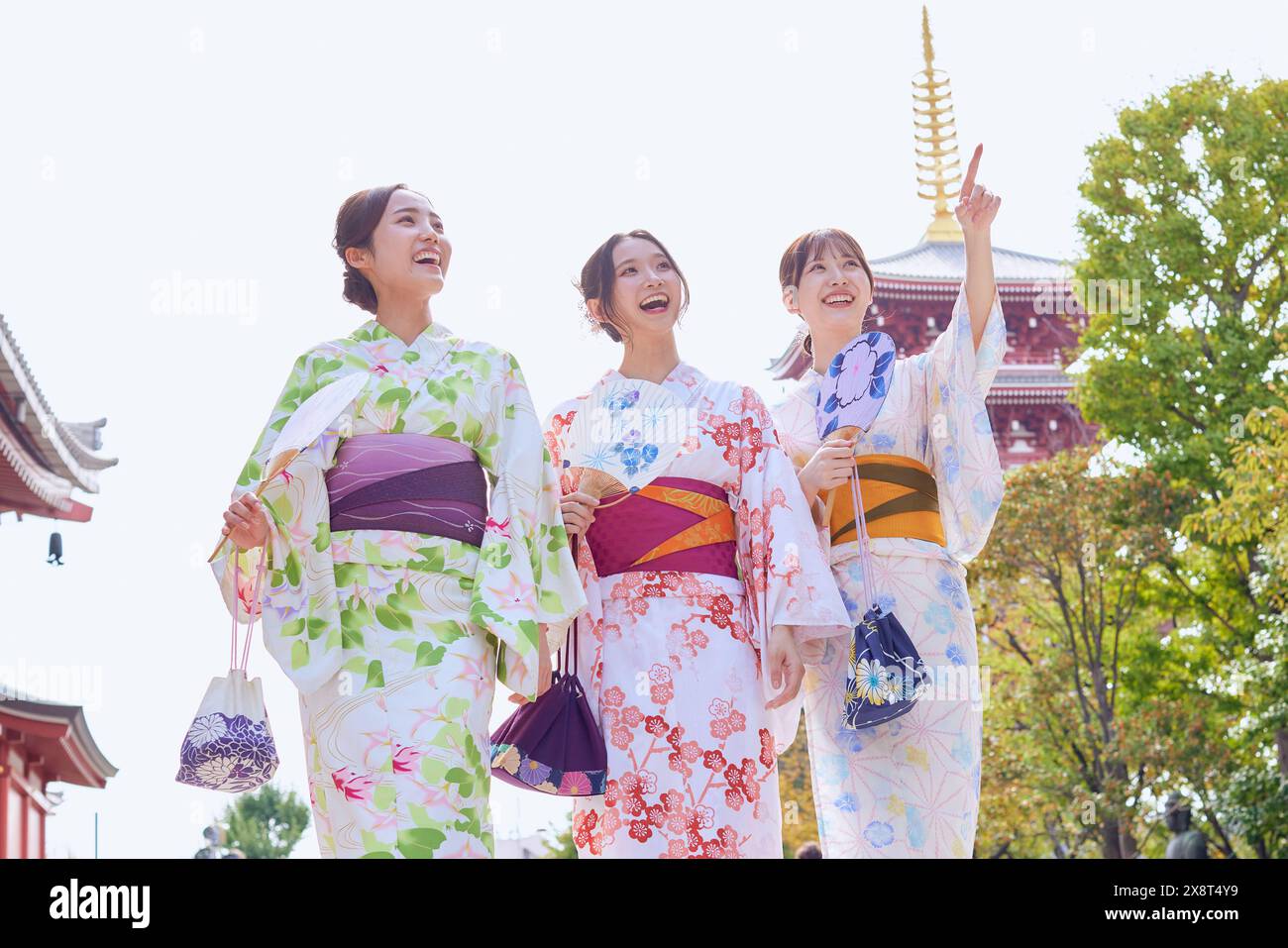 Japanese friends wearing yukata visiting traditional temple in Tokyo ...