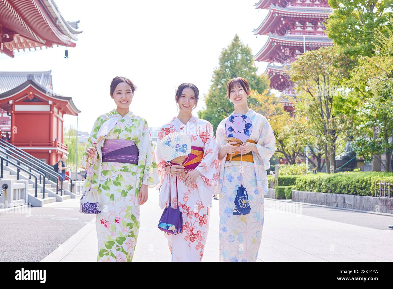Japanese friends wearing yukata visiting traditional temple in Tokyo ...
