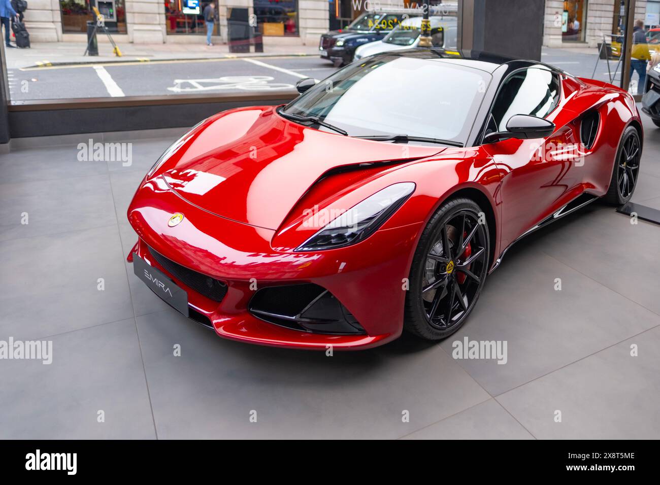 new red Lotus Emira in showroom, British exciting sports car Lotus Cars ...