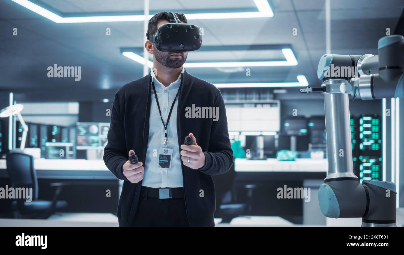 Robotics Engineer Operating a Futuristic Robotic Arm, Using a Virtual Reality Headset and ...