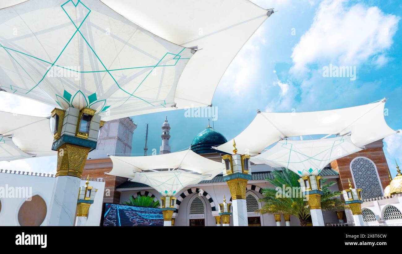 Big umbrella in mosque with a blue sky background Stock Photo - Alamy