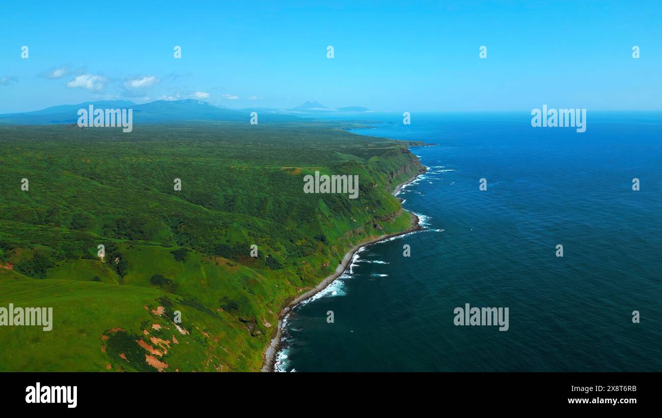 Green fields, meadows, summer blue sky and calm sea. Clip. Picturesque ...