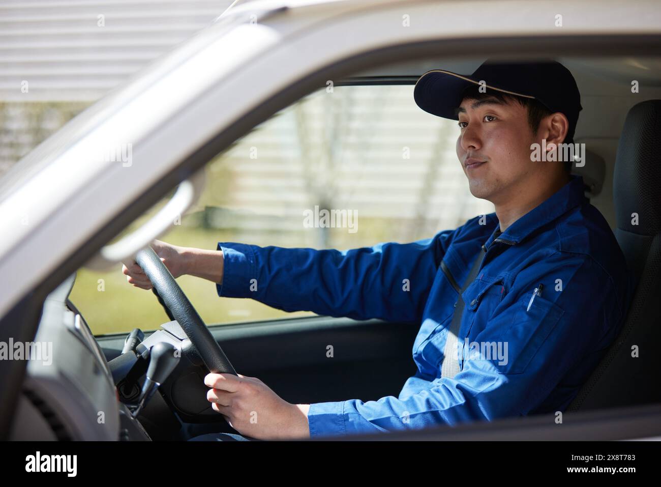 Japanese delivery man driving a car Stock Photo - Alamy