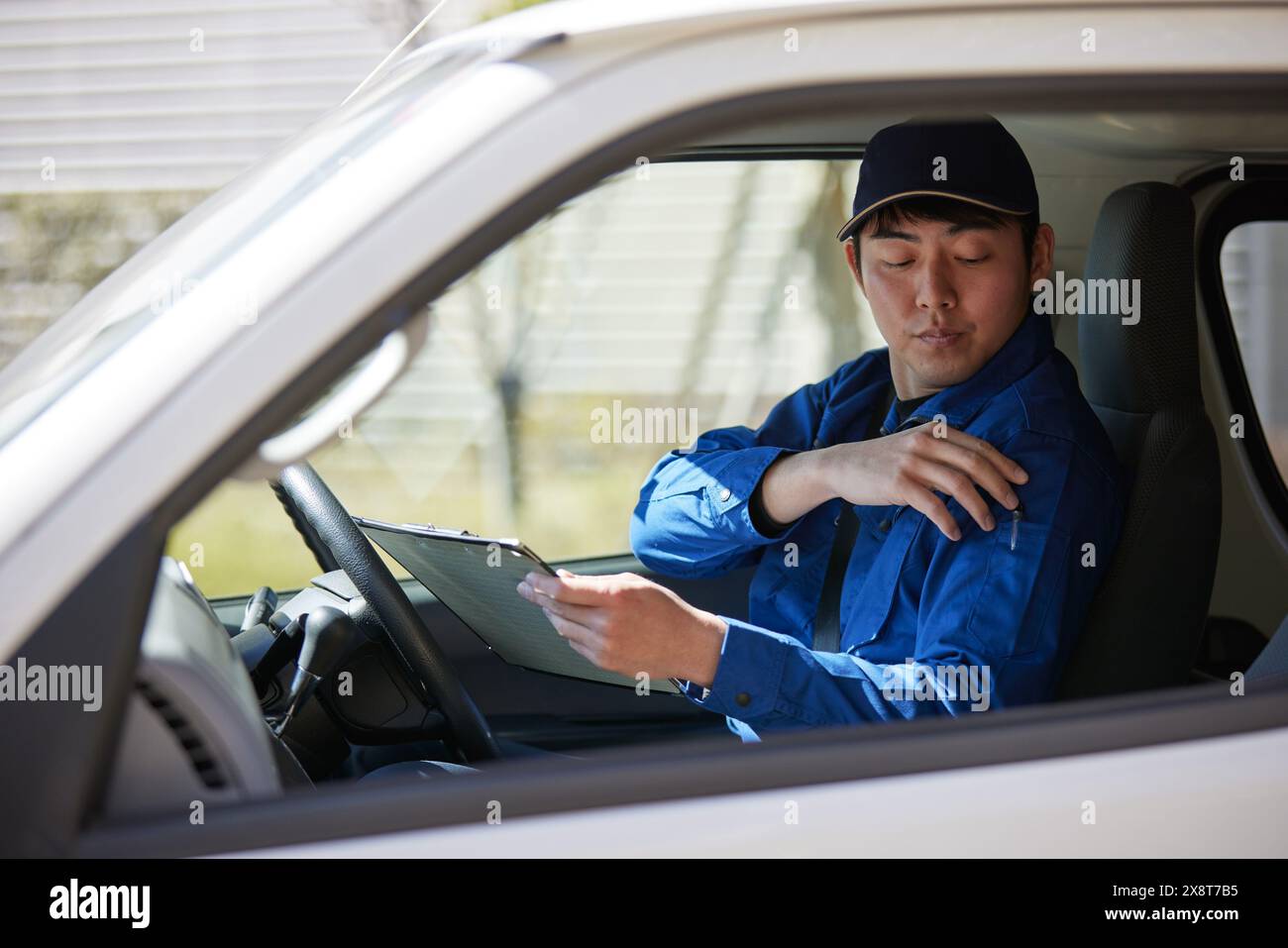 Japanese delivery man sitting in the driver seat of a car Stock Photo ...