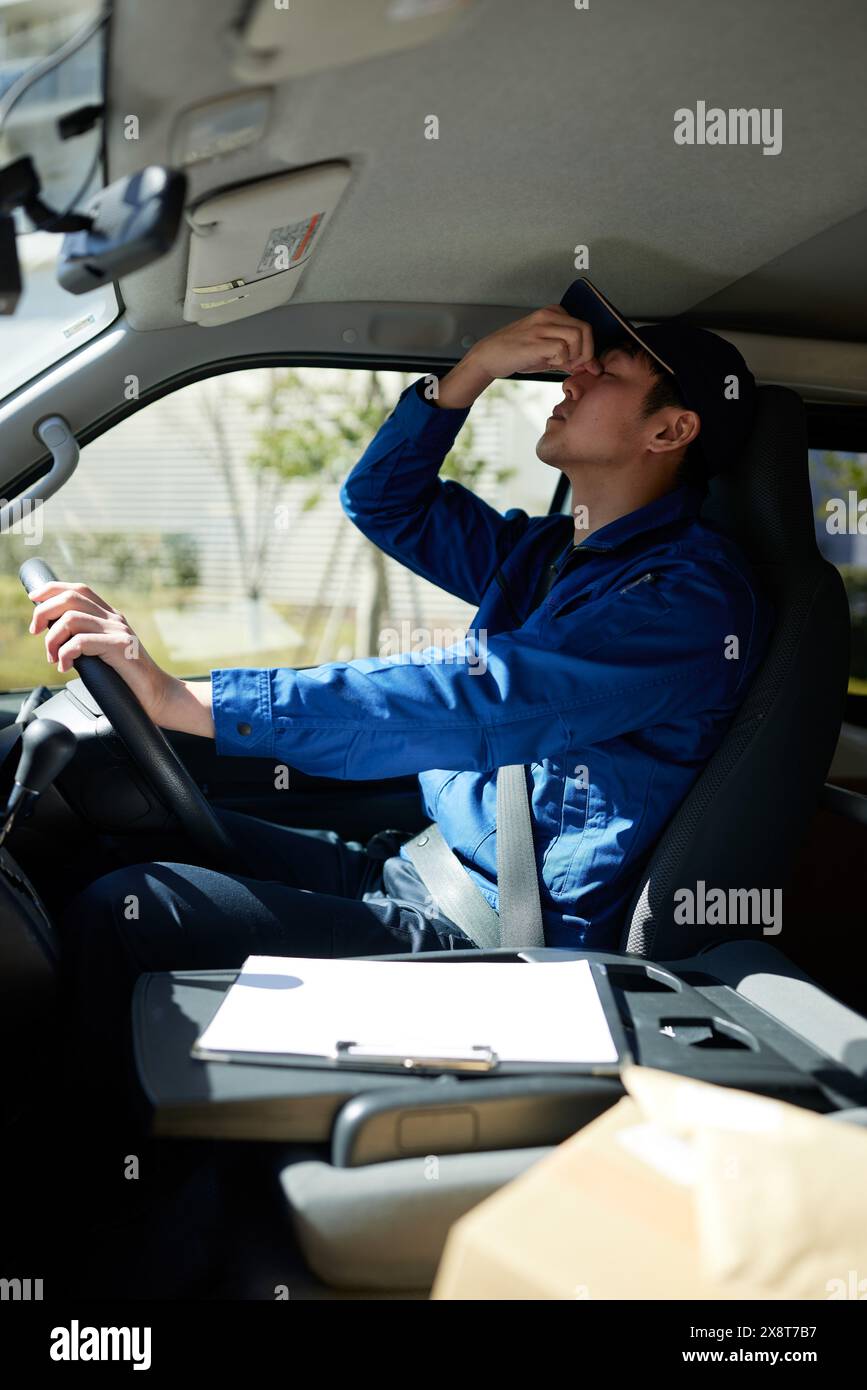 Japanese delivery man sitting in the driver seat Stock Photo - Alamy