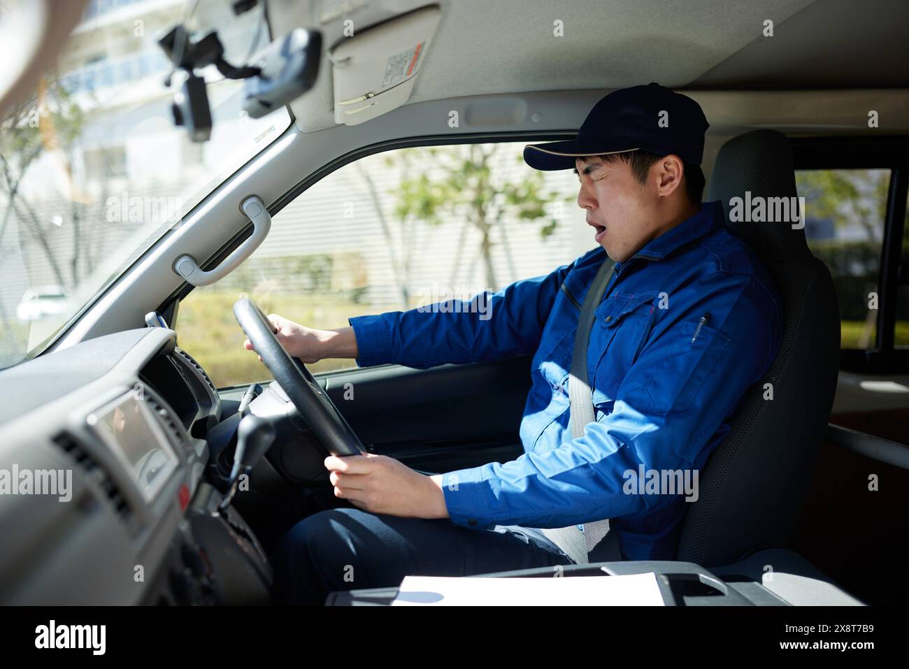 Japanese delivery man driving a car Stock Photo - Alamy