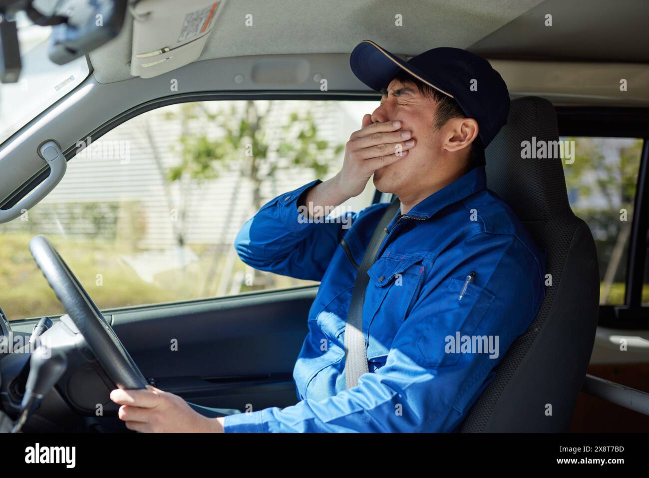 Japanese delivery man sitting in the driver seat Stock Photo - Alamy