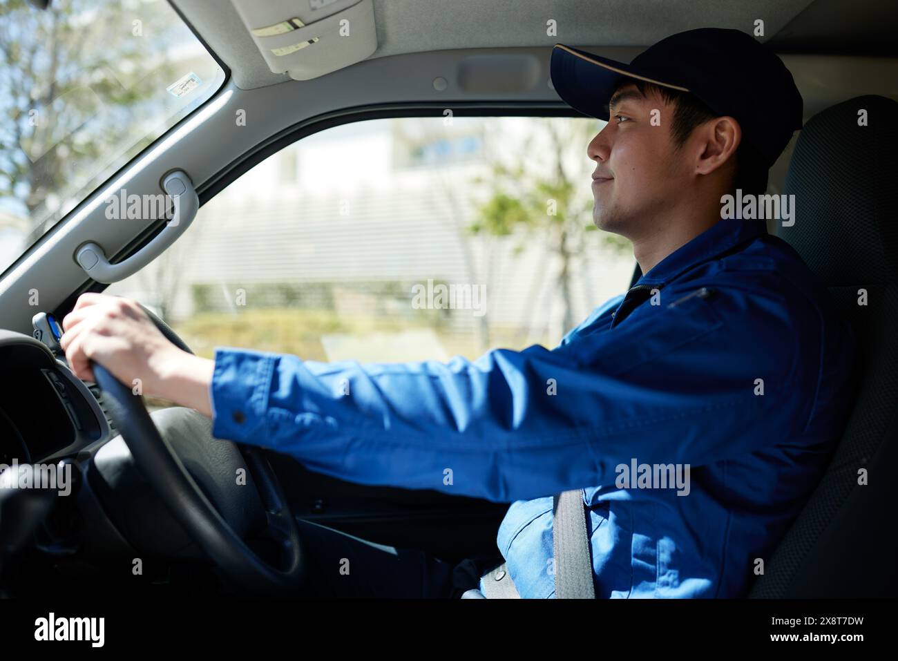 Japanese delivery man sitting in the driver seat Stock Photo - Alamy