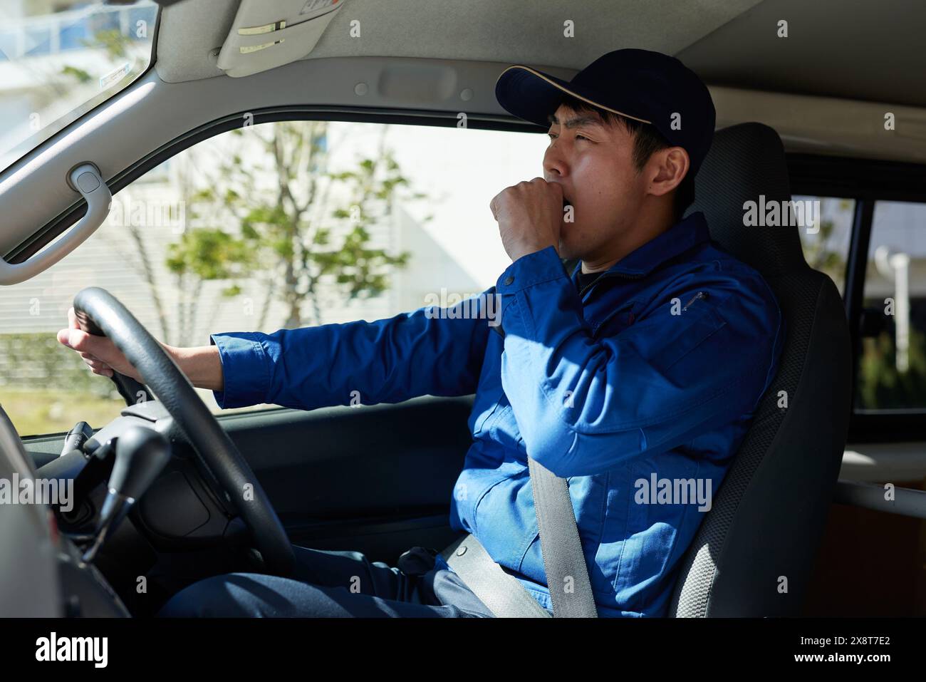 Japanese delivery man sitting in the driver seat Stock Photo - Alamy