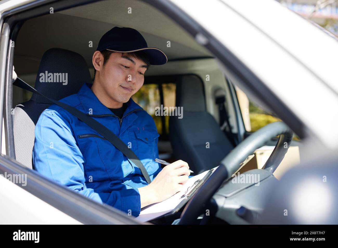 Japanese delivery man sitting in the driver seat Stock Photo - Alamy