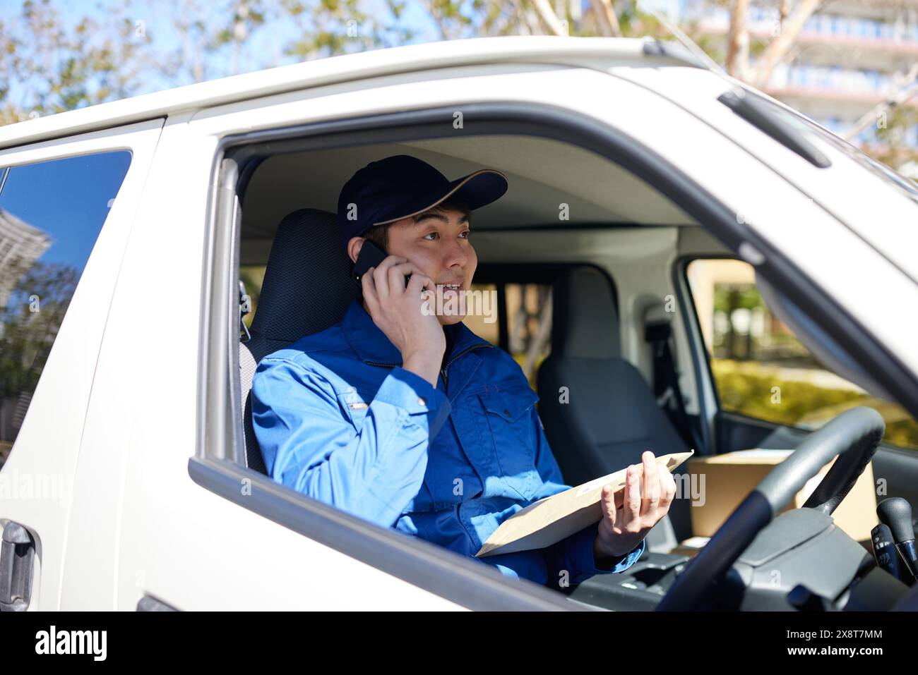 Japanese delivery man sitting in the driver seat Stock Photo - Alamy