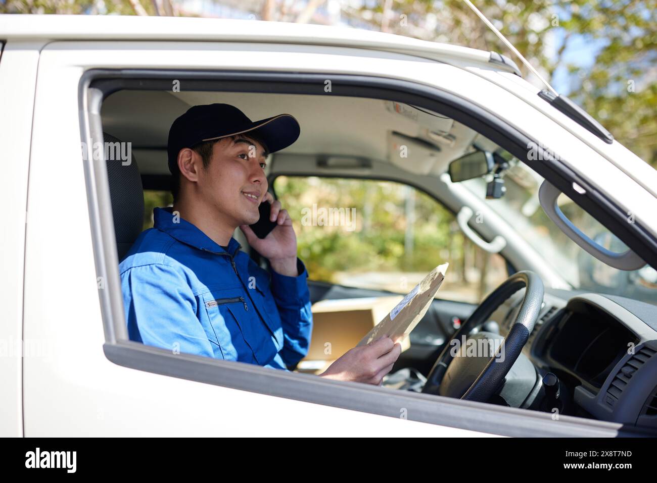 Japanese delivery man sitting in the driver seat Stock Photo - Alamy