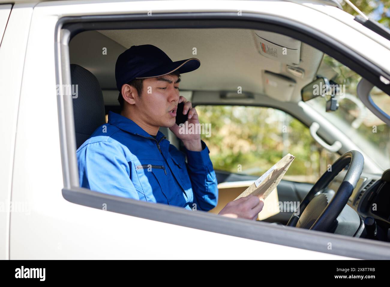 Japanese delivery man sitting in the driver seat Stock Photo - Alamy