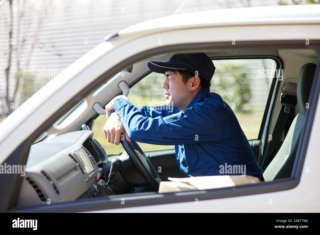 Japanese delivery man sitting in the driver seat Stock Photo - Alamy