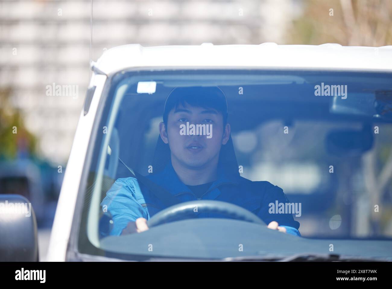 Japanese delivery man sitting in the driver seat Stock Photo - Alamy